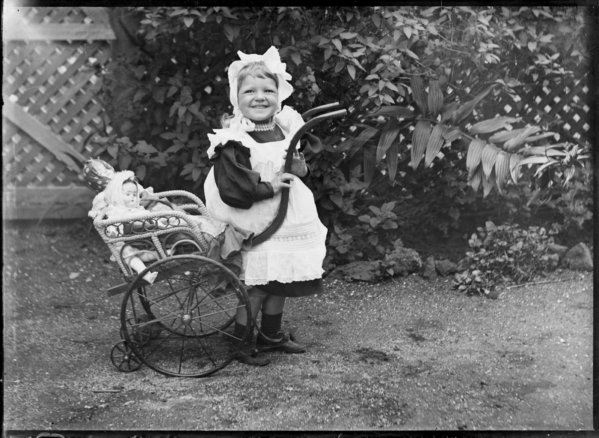 Child pulling doll's pram | Record | DigitalNZ