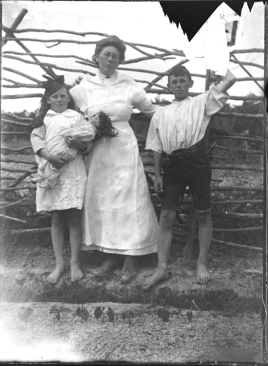 Woman and two children in vegetable garden setting | Record | DigitalNZ