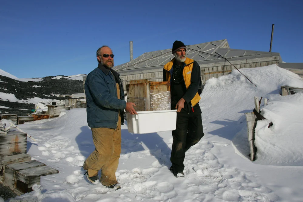 Carrying stores for conservation from Shackleton's Nimrod Hut at Cape ...