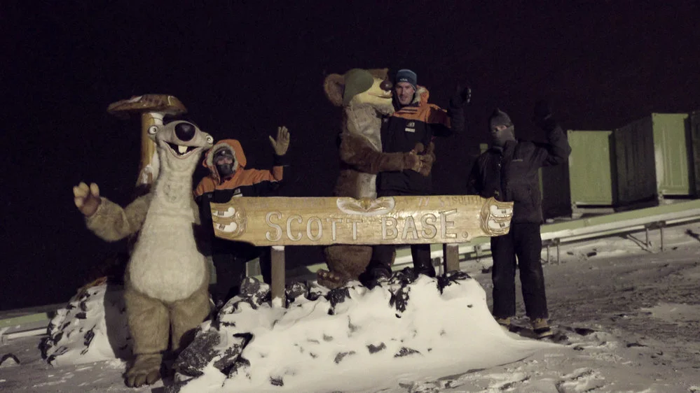 Staff, Sid and Buck at Scott Base sign | Record | DigitalNZ