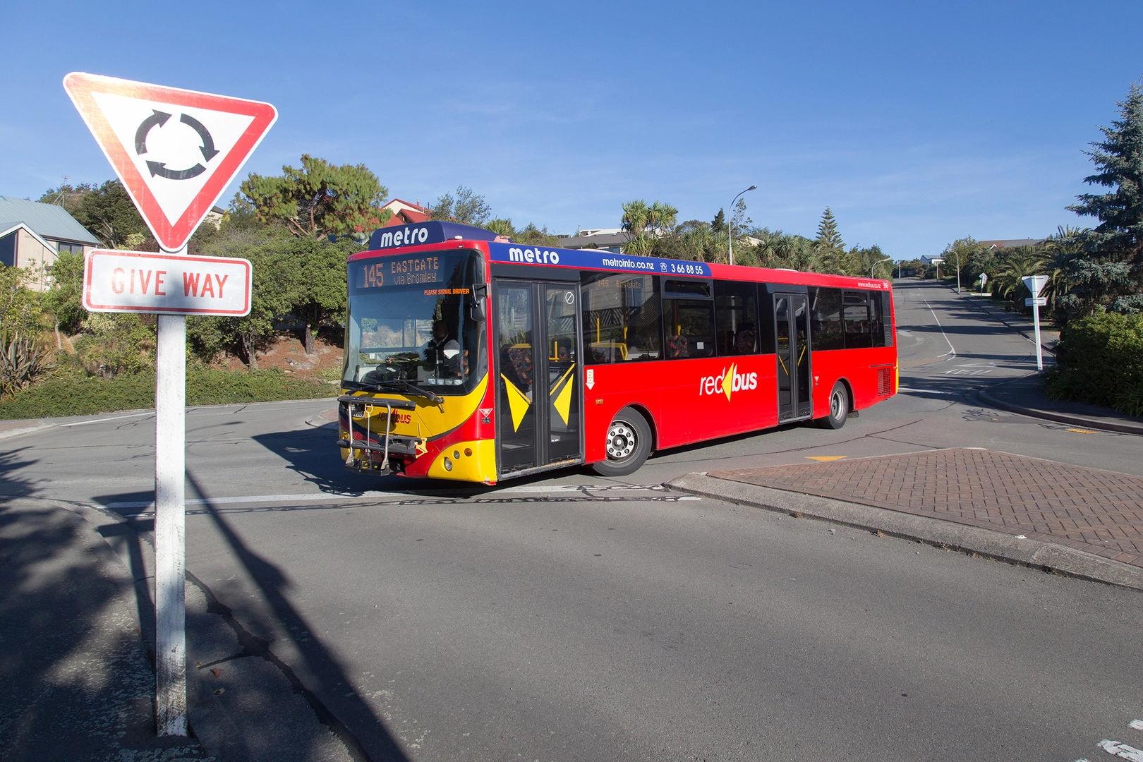 Red bus driving through Westmorland | Record | DigitalNZ