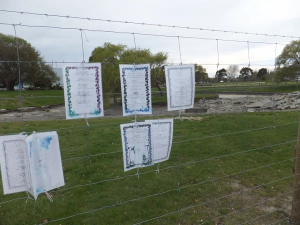 Poems hanging on a fence | Record | DigitalNZ