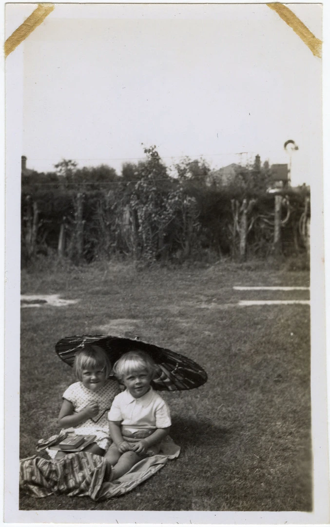 Connie and Ray Macefield sitting on grass with an umbrella | Record ...