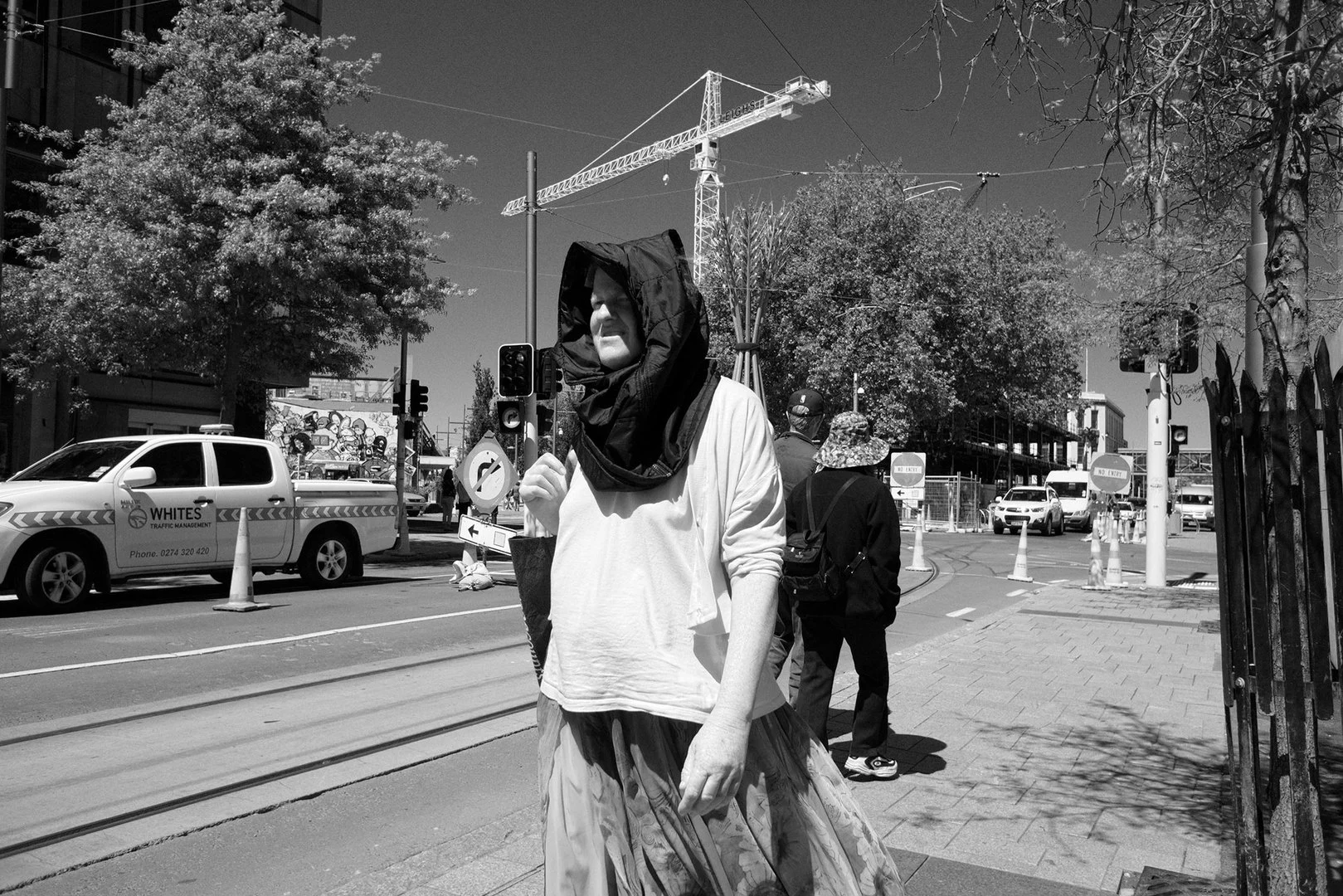 Hooded pedestrian on Colombo Street | Record | DigitalNZ