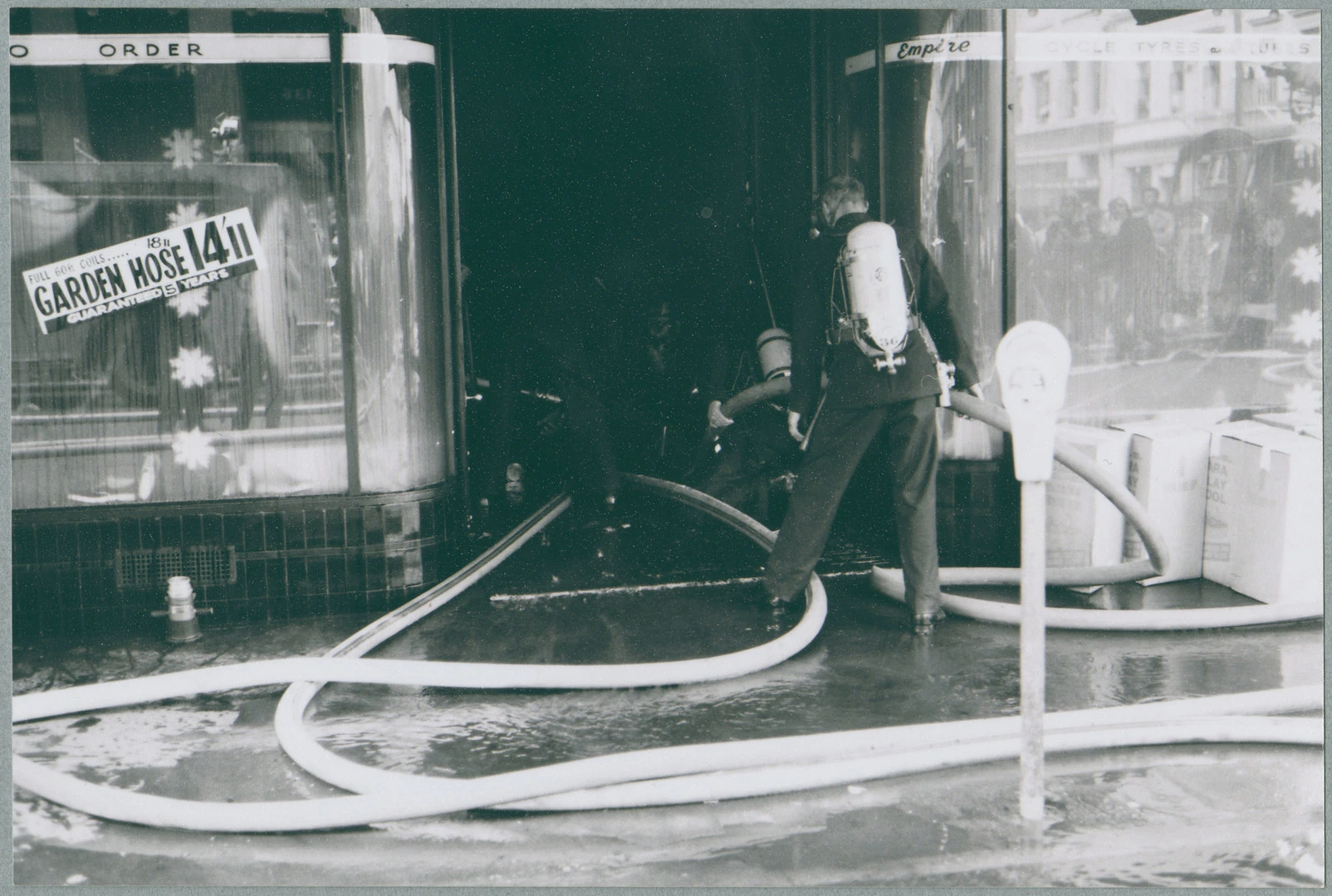 Firefighter with a breathing apparatus tank | Record | DigitalNZ