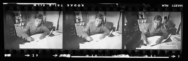 Roger Carter arranging written music | Record | DigitalNZ