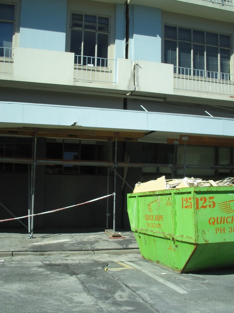 Earthquake damaged building and skip | Record | DigitalNZ
