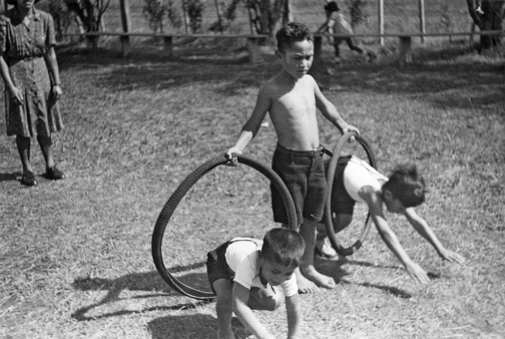 Boys diving through 'hoops' of bicycle tyres | Record | DigitalNZ