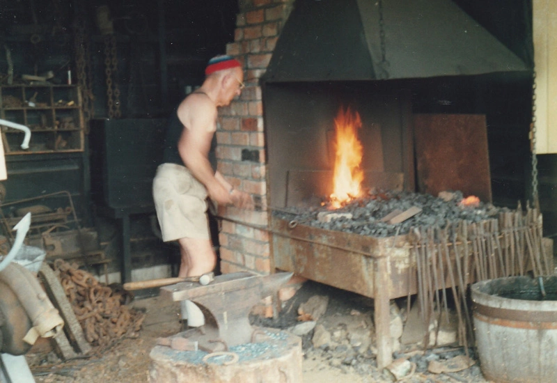 Stan Butler at work in Wagstaff's Forge in Howick Historical Village. | Record | DigitalNZ