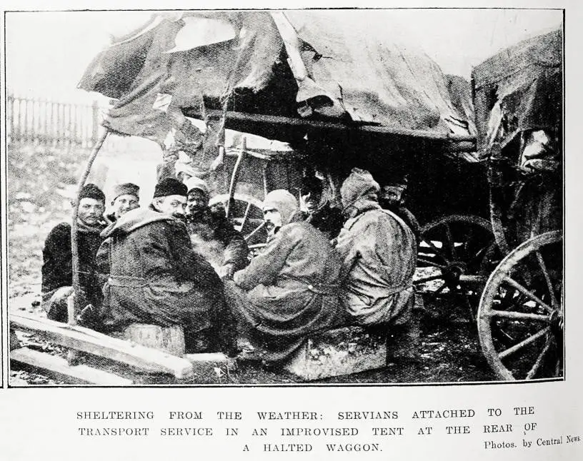 Sheltering from the weather. Servians attached to the transport service ...