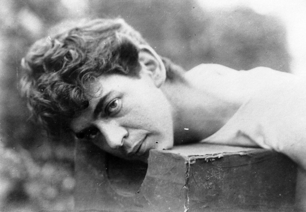 A theatrical scene of a man with his head on an execution block ...