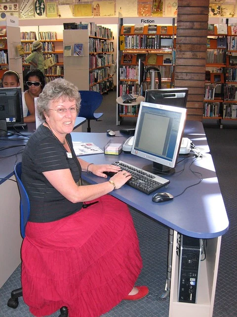 Librarian Sandy Green using computer at Masterton Library | Record ...