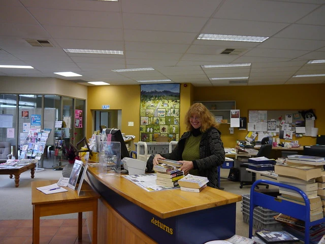Library staff member at the returns counter | Record | DigitalNZ