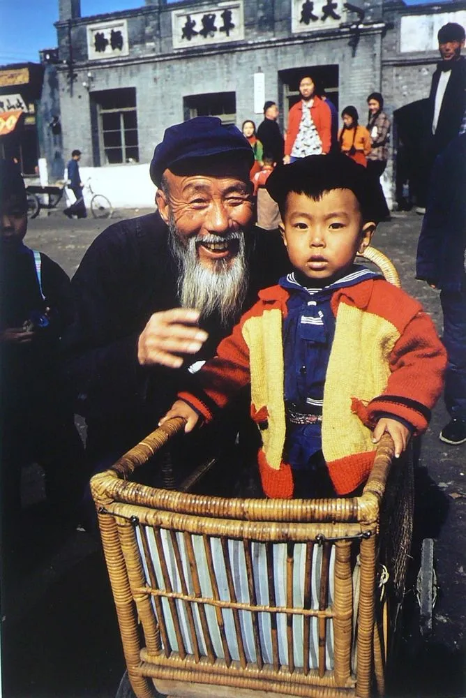 Child in rattan pram with grandfather | Record | DigitalNZ