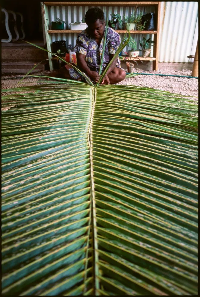 Woman with coconut palm leaf, Vanuatu | Record | DigitalNZ