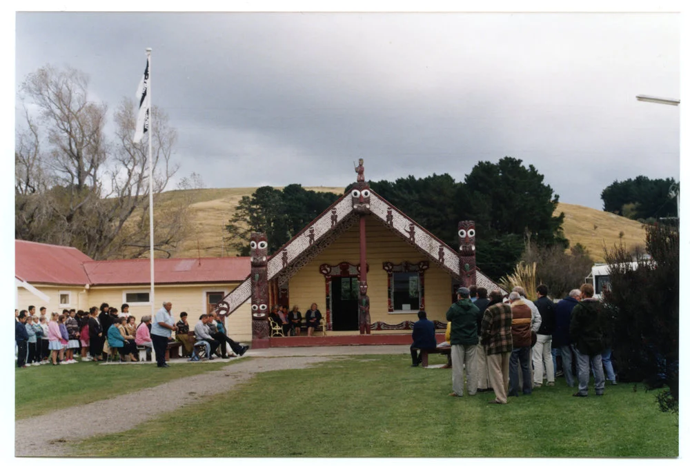 The meeting house at Porangahau Marae with people gathered outside ...